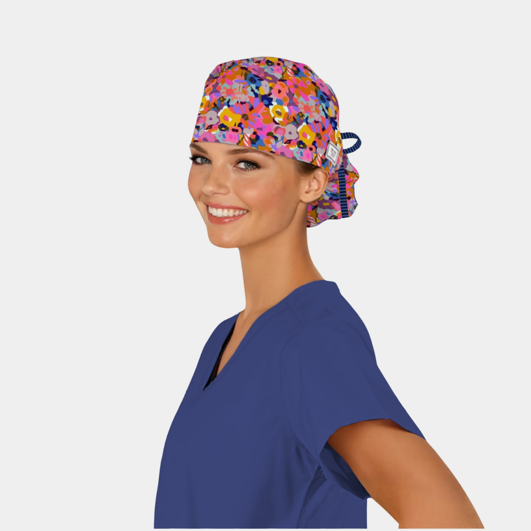 woman wearing a floral ponytail scrub hat from Blue Sky Scrubs with a ...