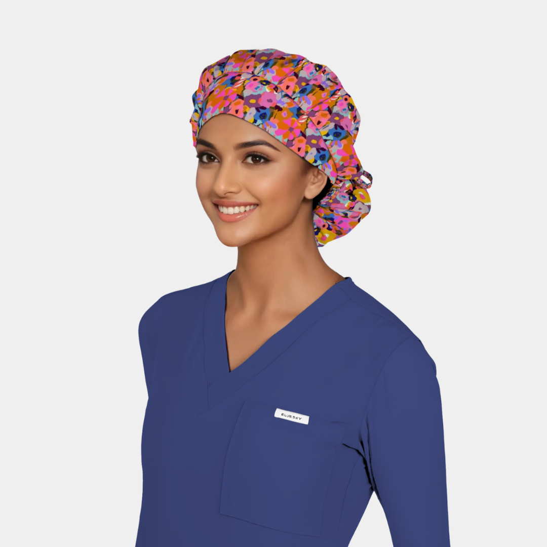 woman wearing a colorful floral bouffant scrub hat and a navy blue long ...