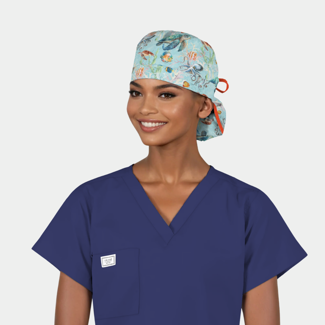 Person wearing a blue scrub top and sea life patterned scrub cap on a ...