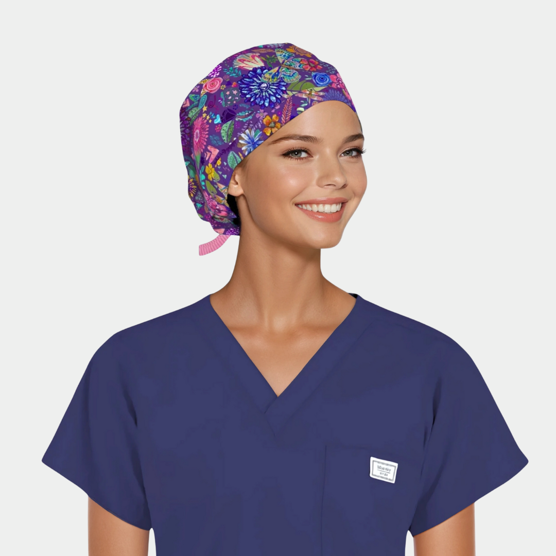 Person wearing a colorful scrub cap and navy blue scrub top on a white ...