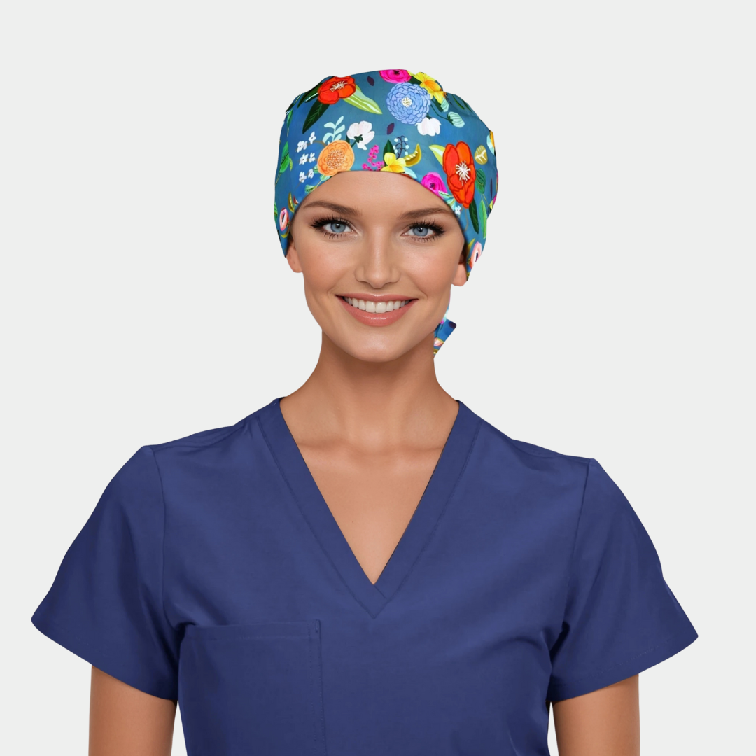 Woman wearing a blue scrub top and colorful floral scrub cap on a light ...
